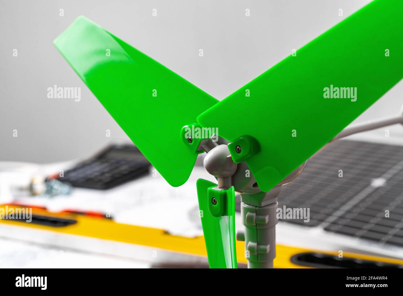 Models of windmill and solar panel on desk of engineer Stock Photo - Alamy