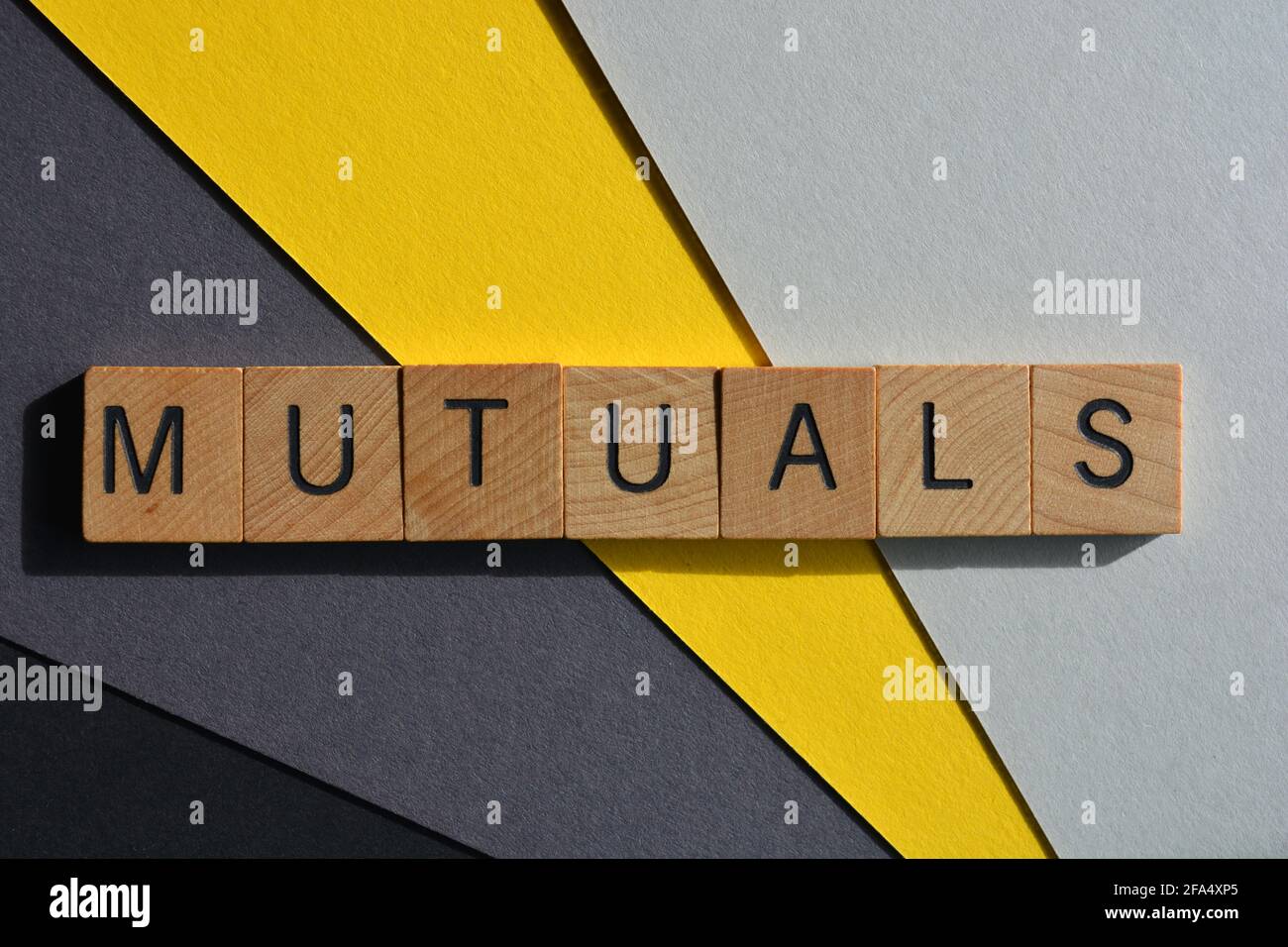 Mutuals, word in wooden alphabet letters isolated on yellow and grey ...