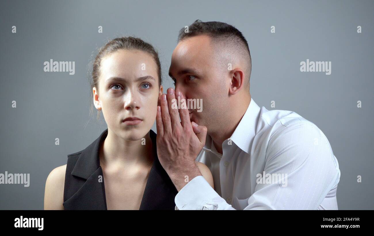 Shooting of two gossipers on grey background Stock Photo - Alamy