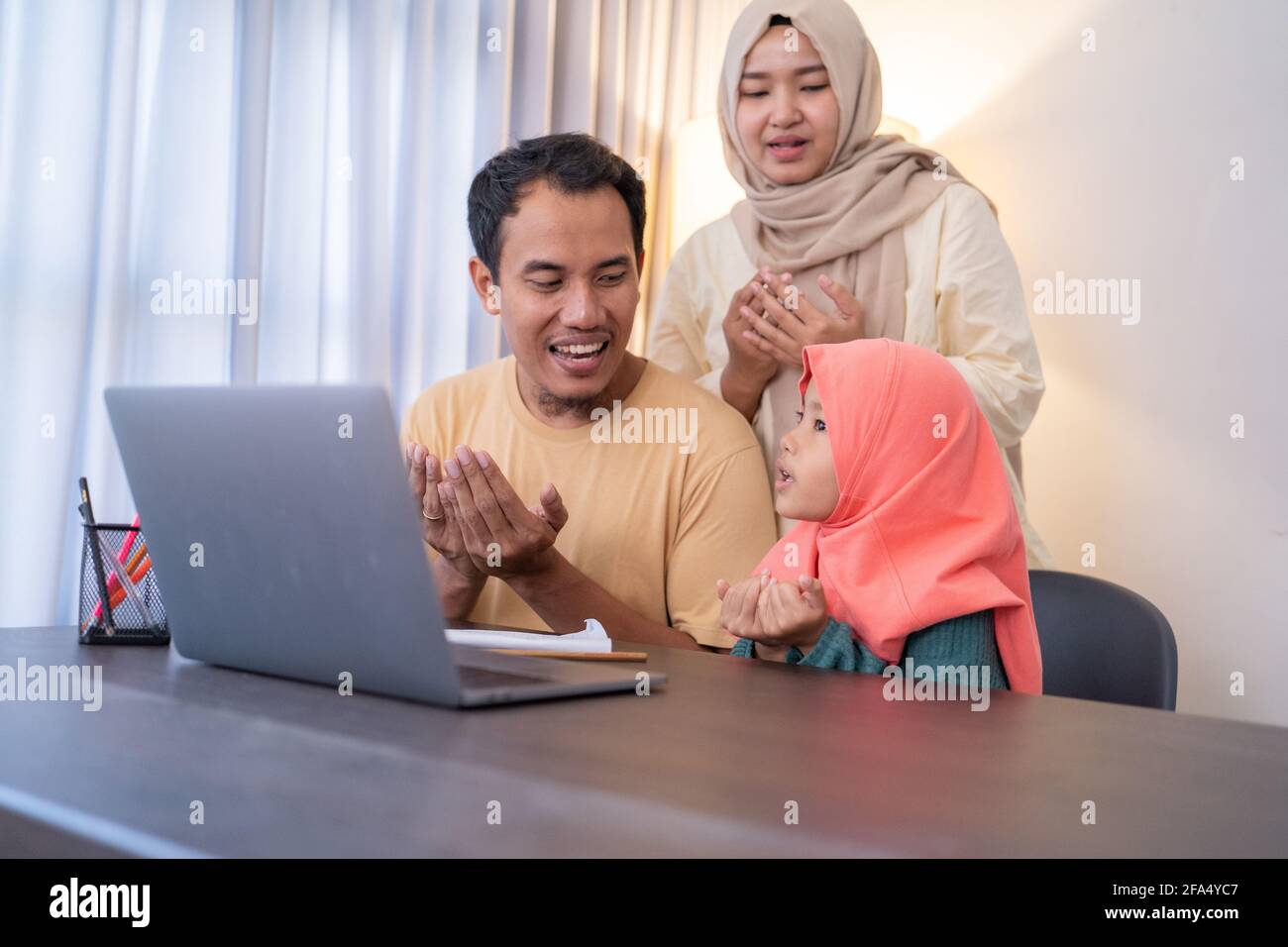 Indonesian muslim family learning together hi-res stock photography and ...