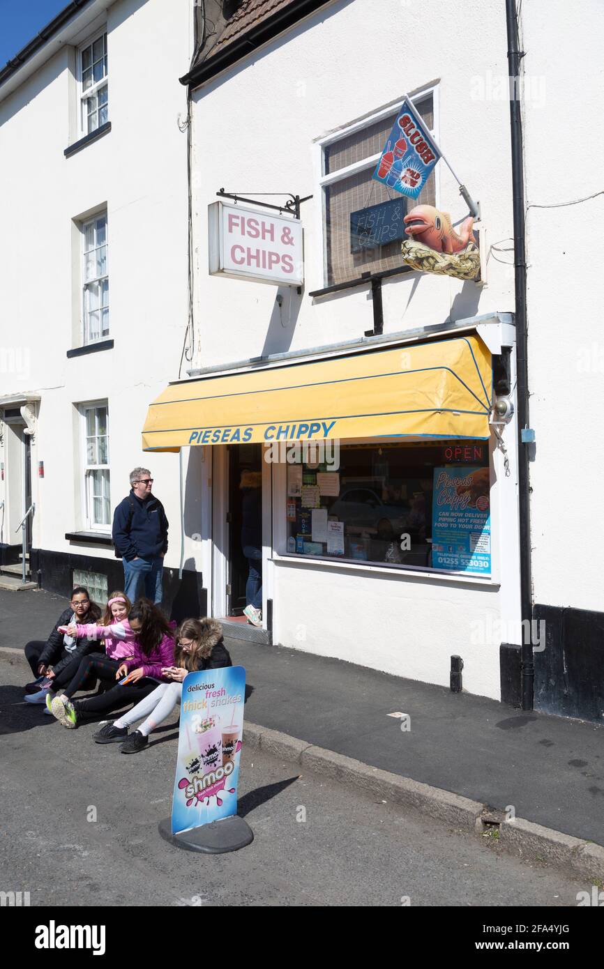 People sitting outside Pieseas chippy chip shop. Harwich, Essex ...