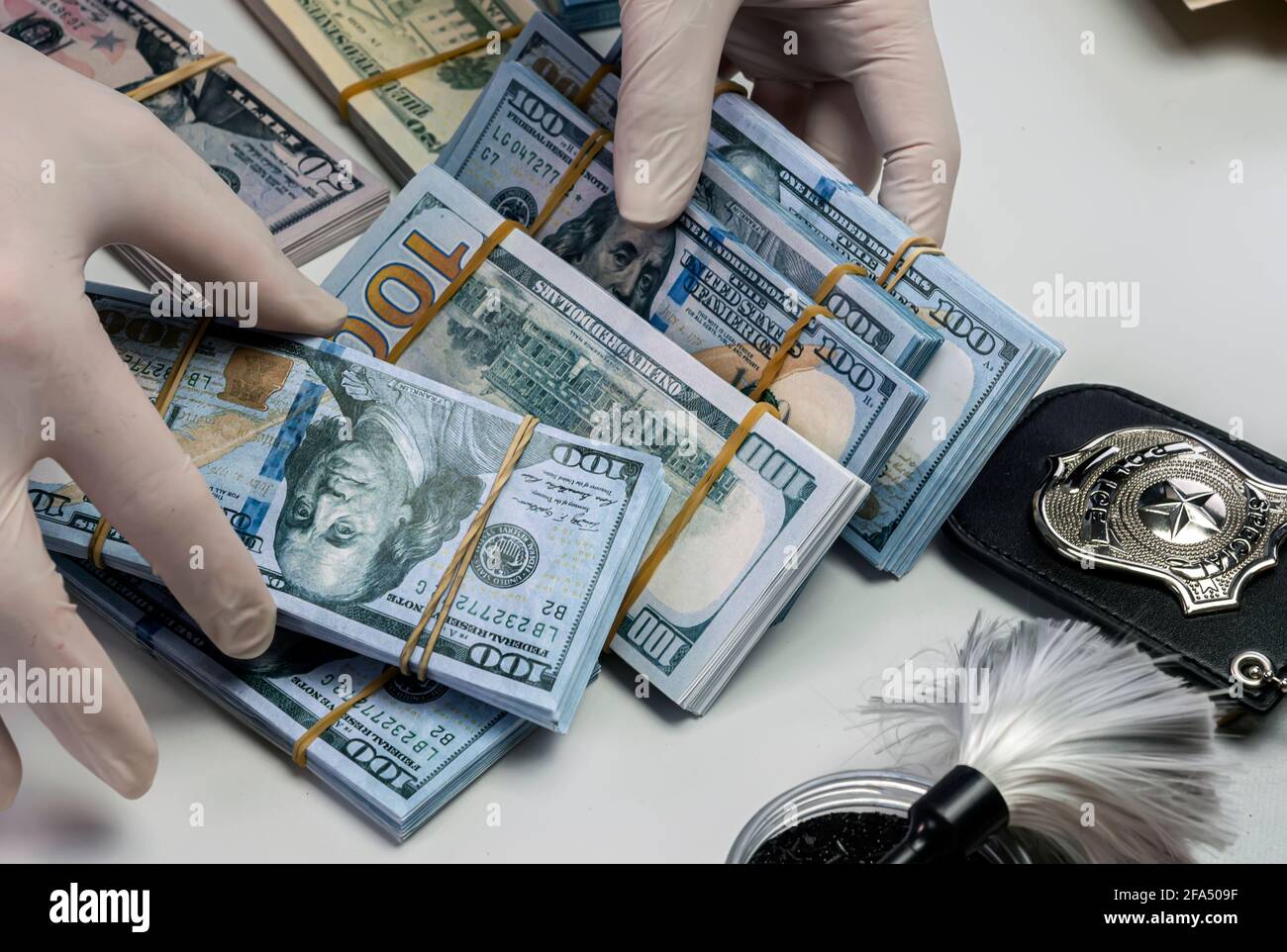 Specialised police officer notes dollar banknote reference of a robbery ...