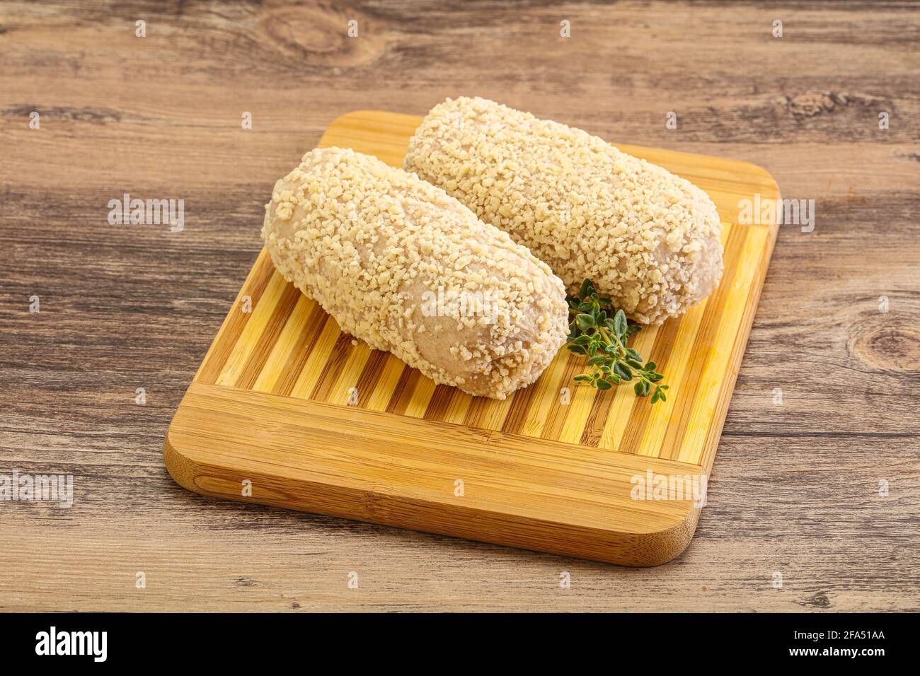 Raw breaded chicken cutlet for roast Stock Photo - Alamy