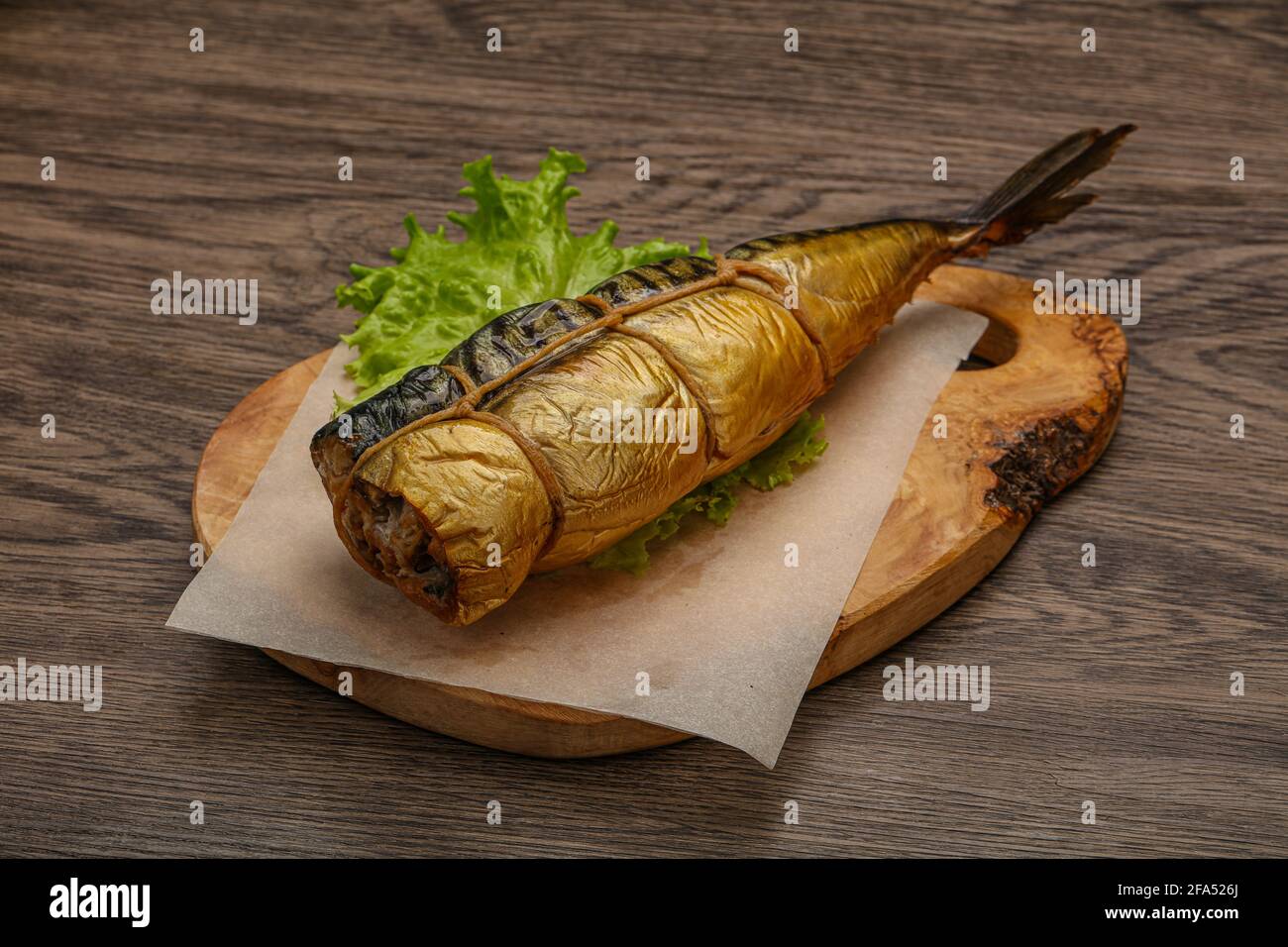 Smoked tasty mackerel fish snack over board Stock Photo - Alamy