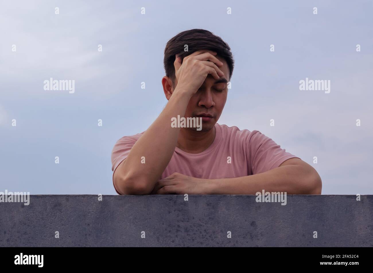 Asian miserable depressed man stay alone with sky background ...