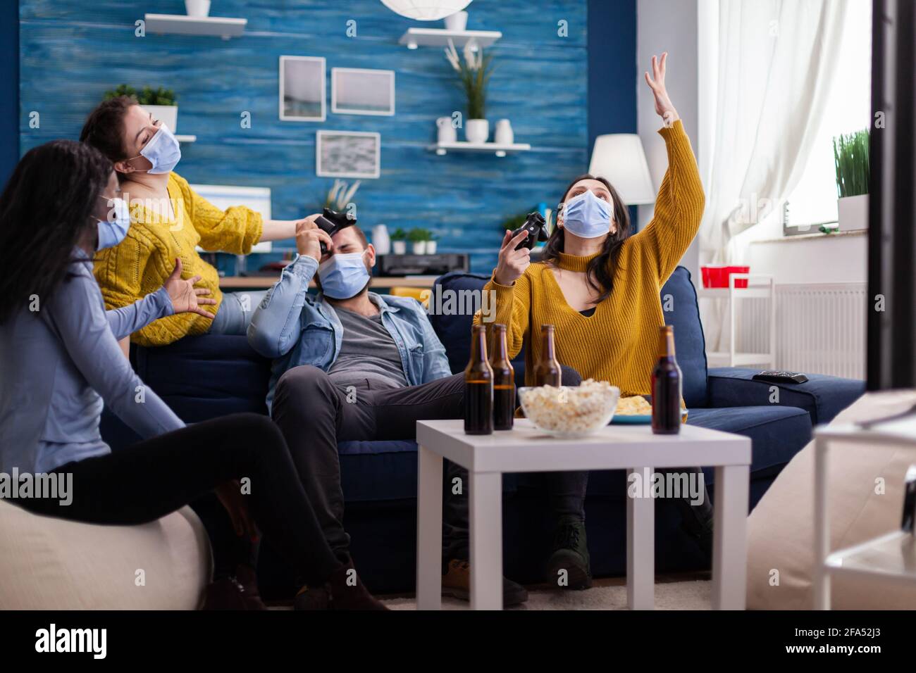 Multi ethnic friends angry because they lost at video games wearing ...