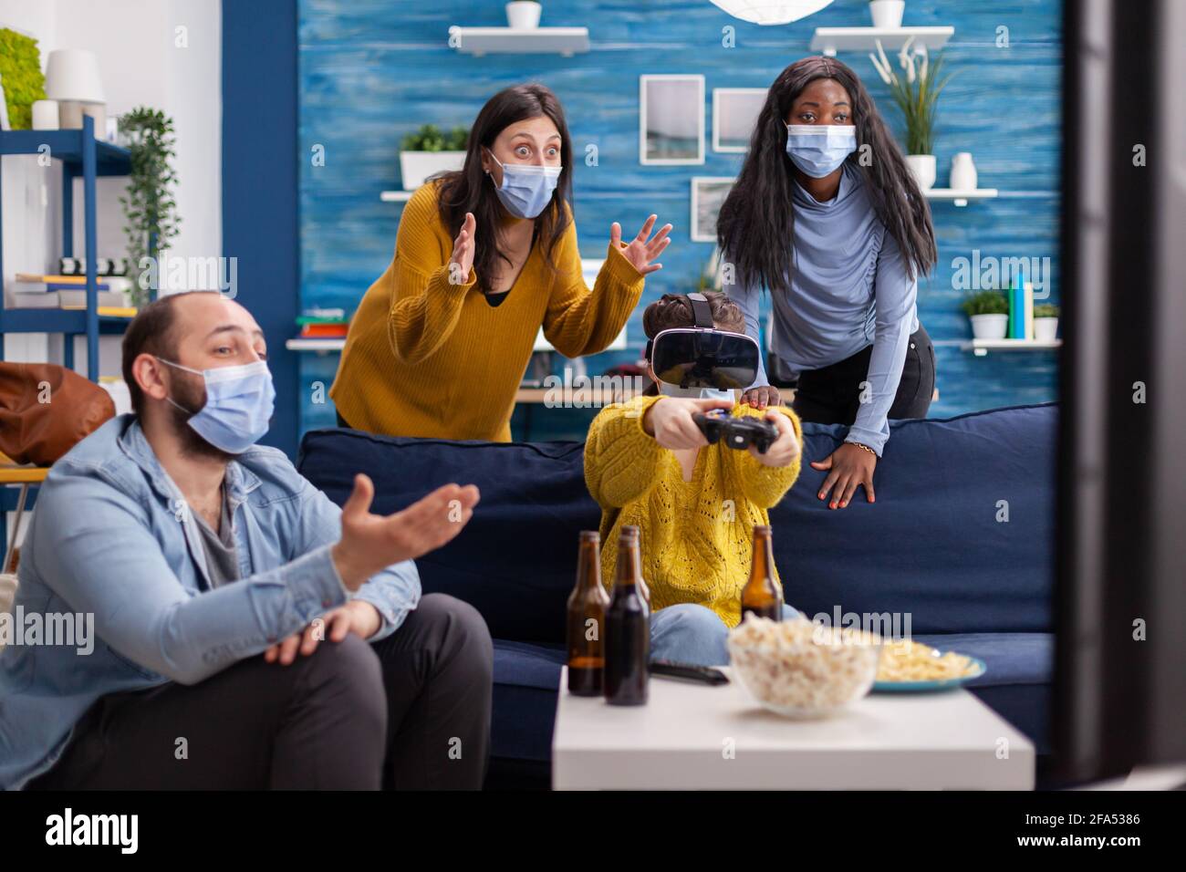 Woman playing video games wearing vr headset and multiethnic friends ...