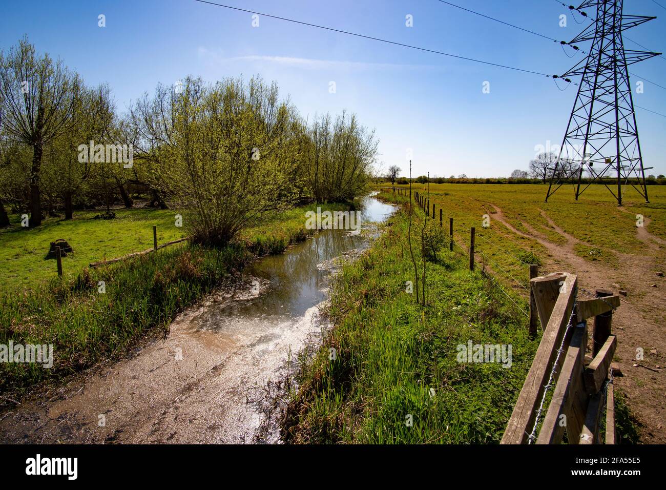 Stream next to a farm field Stock Photo - Alamy