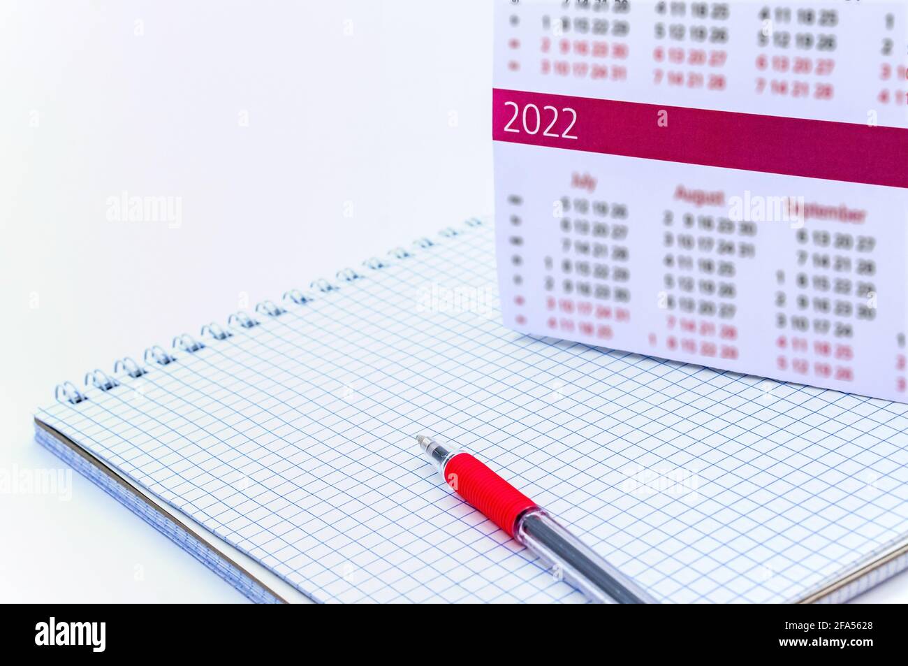 Notepad and calendar 2022. Red pen and Notepad on a white background ...