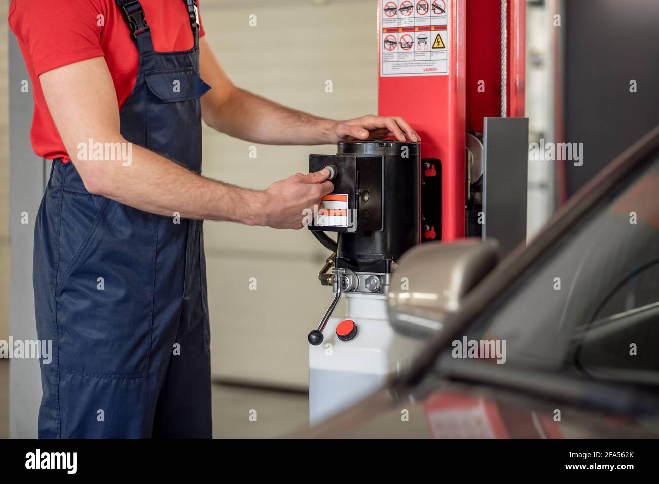 Male hands pressing button of device in garage Stock Photo - Alamy Male hands pressing button of device in garage Stock Photo - Alamy