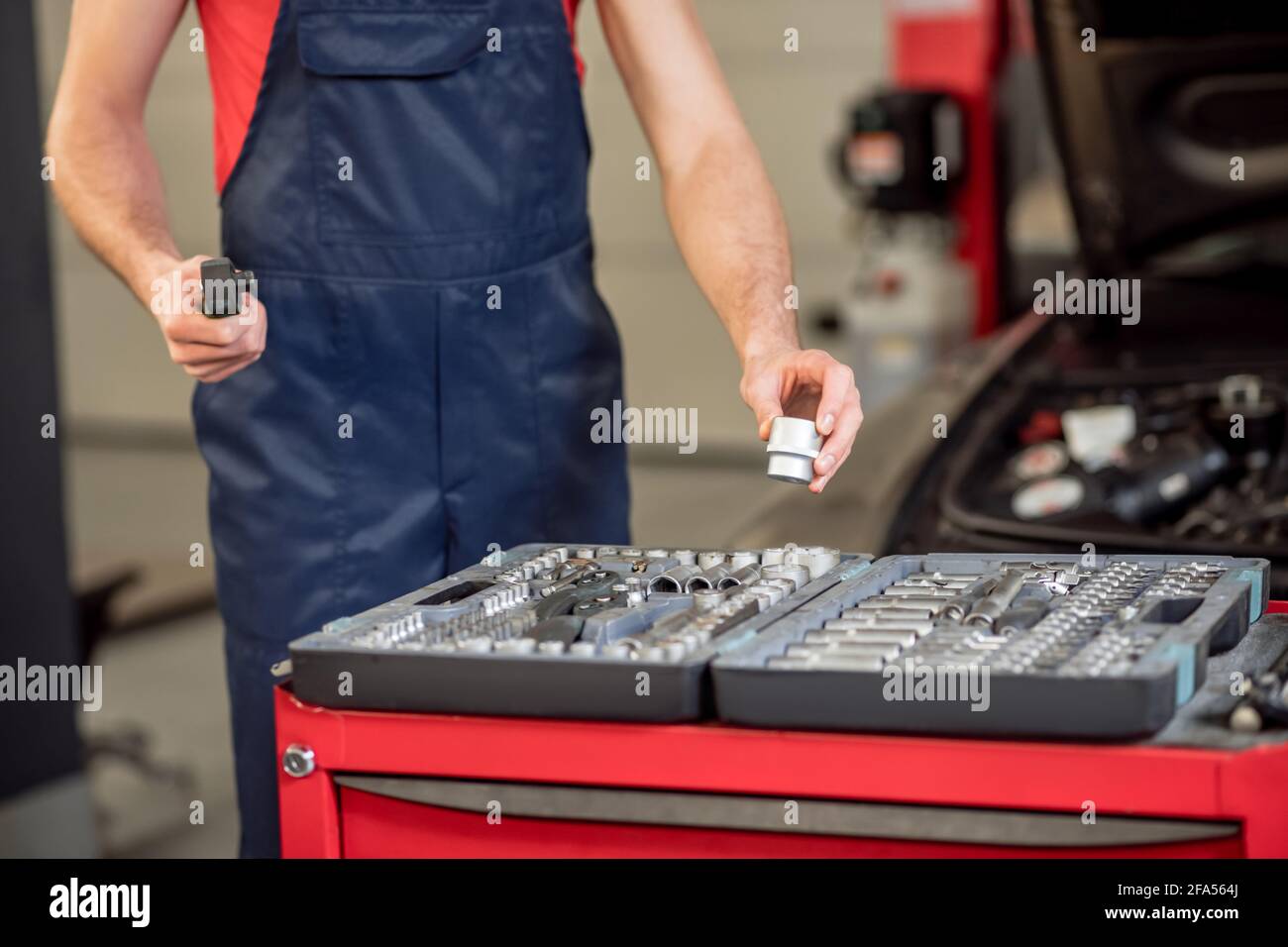 Mechanic holding spare part hi-res stock photography and images - Alamy