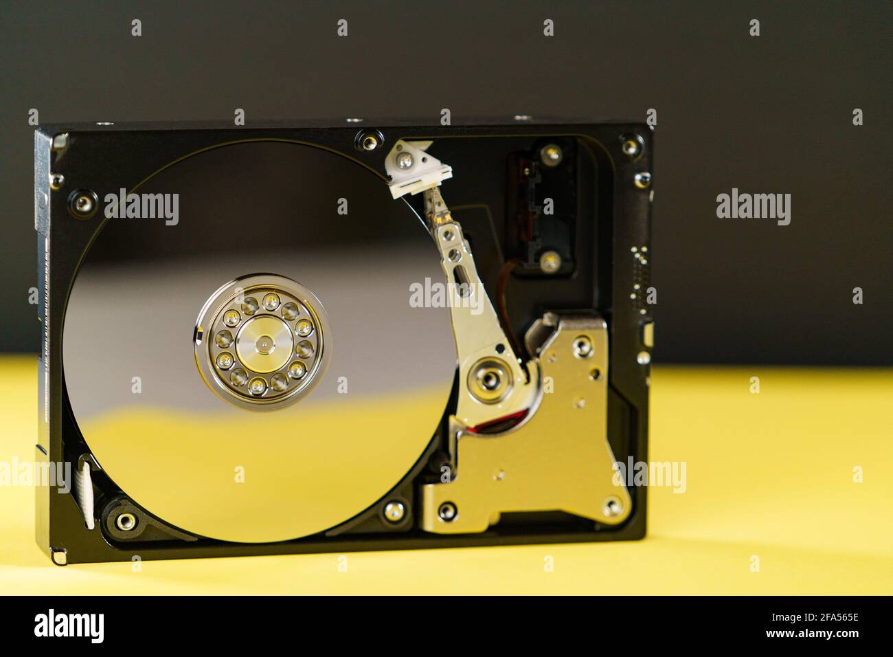 hdd disk on yellow black background Stock Photo - Alamy