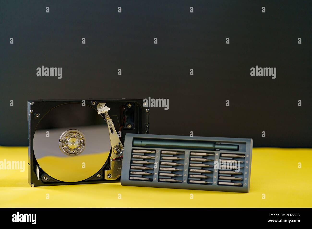 hdd disk with screwdriver repair kit on yellow black background Stock ...