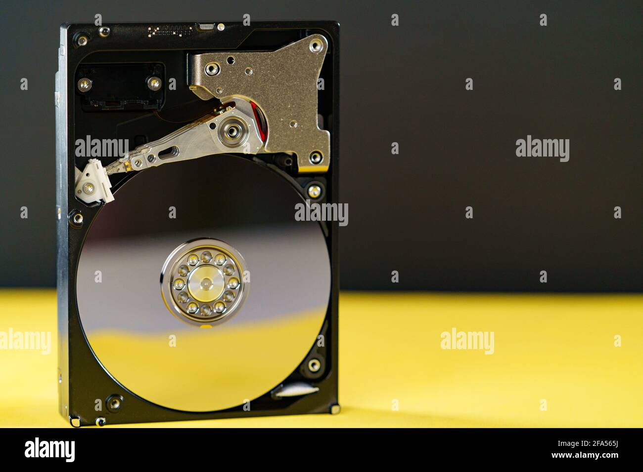 hdd disk on yellow black background Stock Photo - Alamy