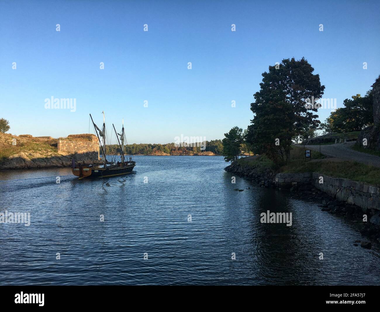 Old sailing ship leaving an inlet in the North Sea in a sunny day. High ...
