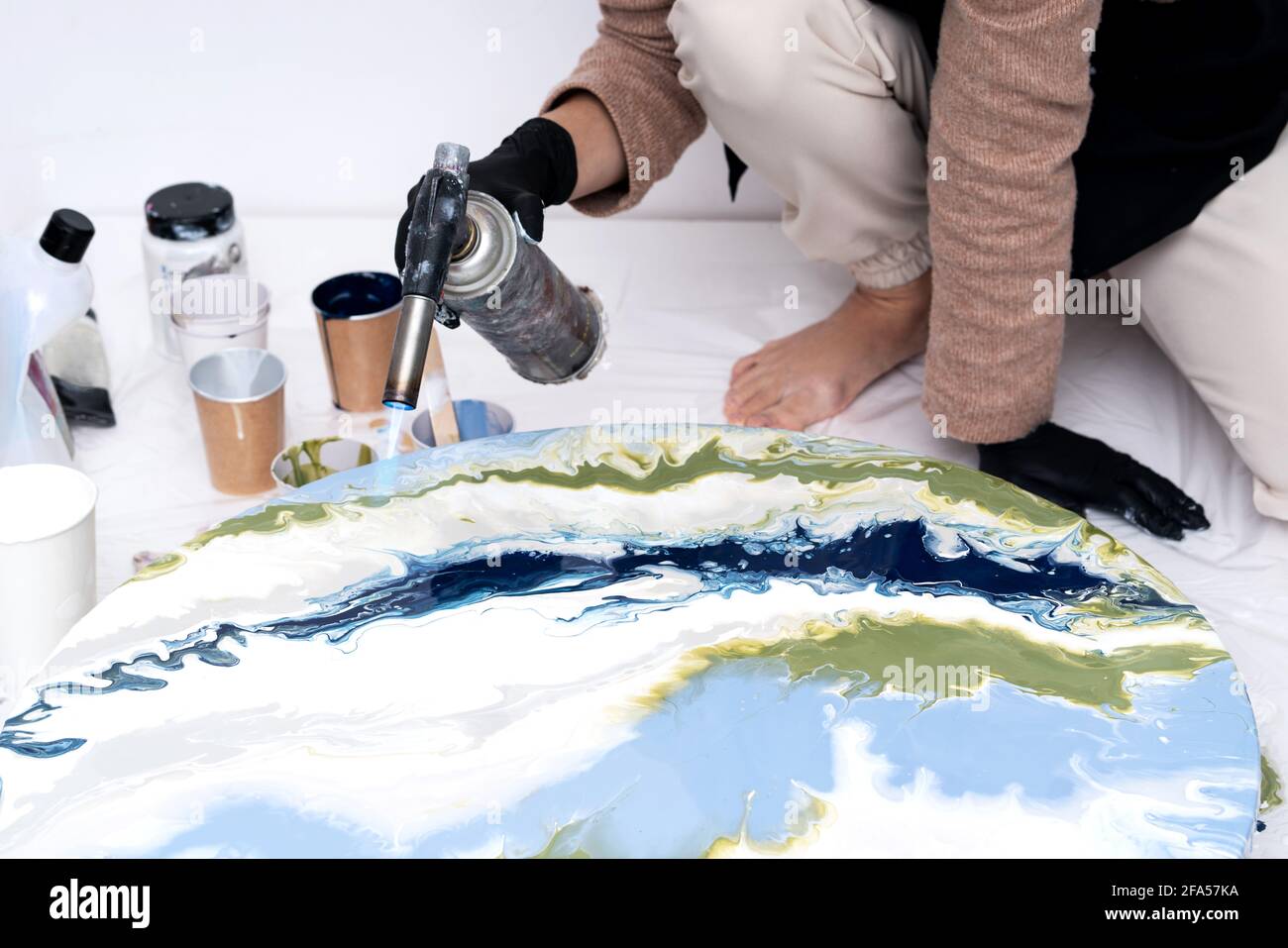 The process of creating a painting using fluid art technique Stock ...