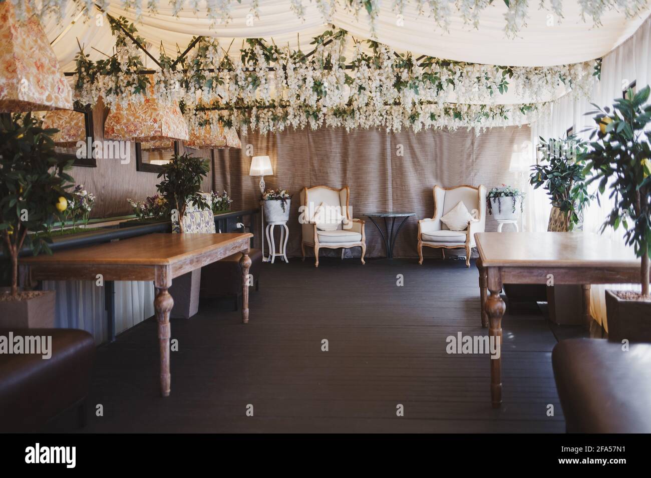 stylish interior of a european cafe or restaurant with flowers on the ...