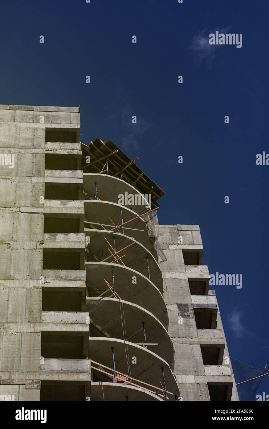 unfinished high-rise building on a construction site. The new building ...
