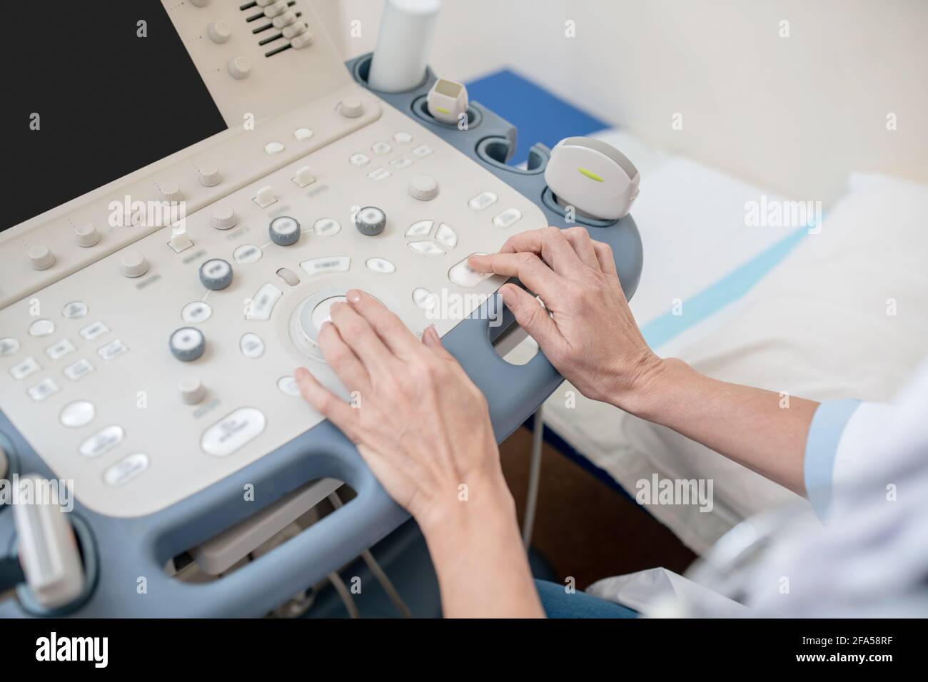 Doctors hands on the ultrasound control panel Stock Photo - Alamy