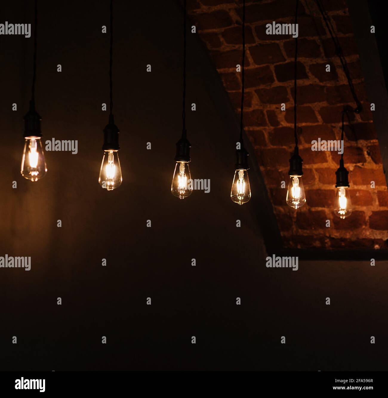 hanging edison bulbs in dark interior restaurant Stock Photo - Alamy