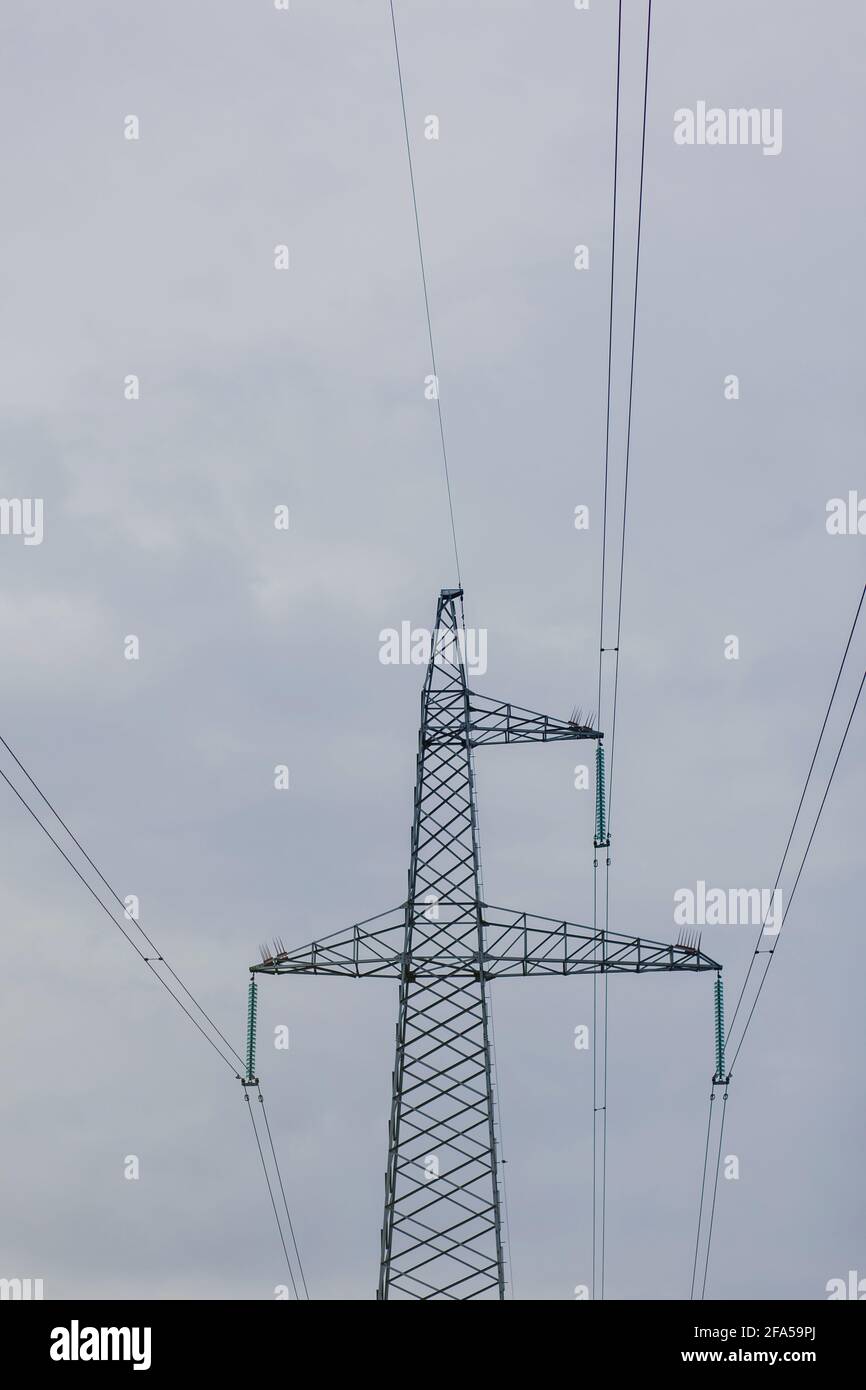 Power mast for high voltage electricity with cables on sky background ...