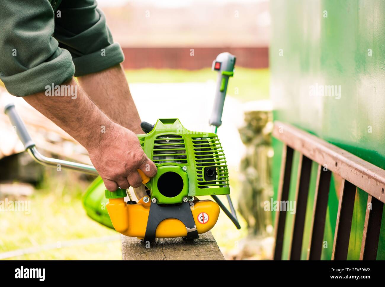 grass-cutter preparing to work on spring farmland soil Stock Photo - Alamy