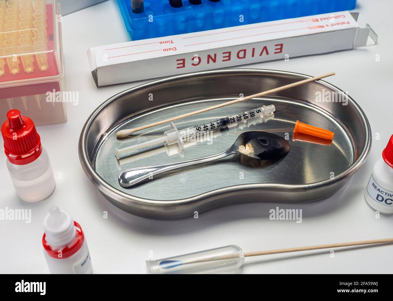 Syringe and spoon in police drug investigation department, concept ...