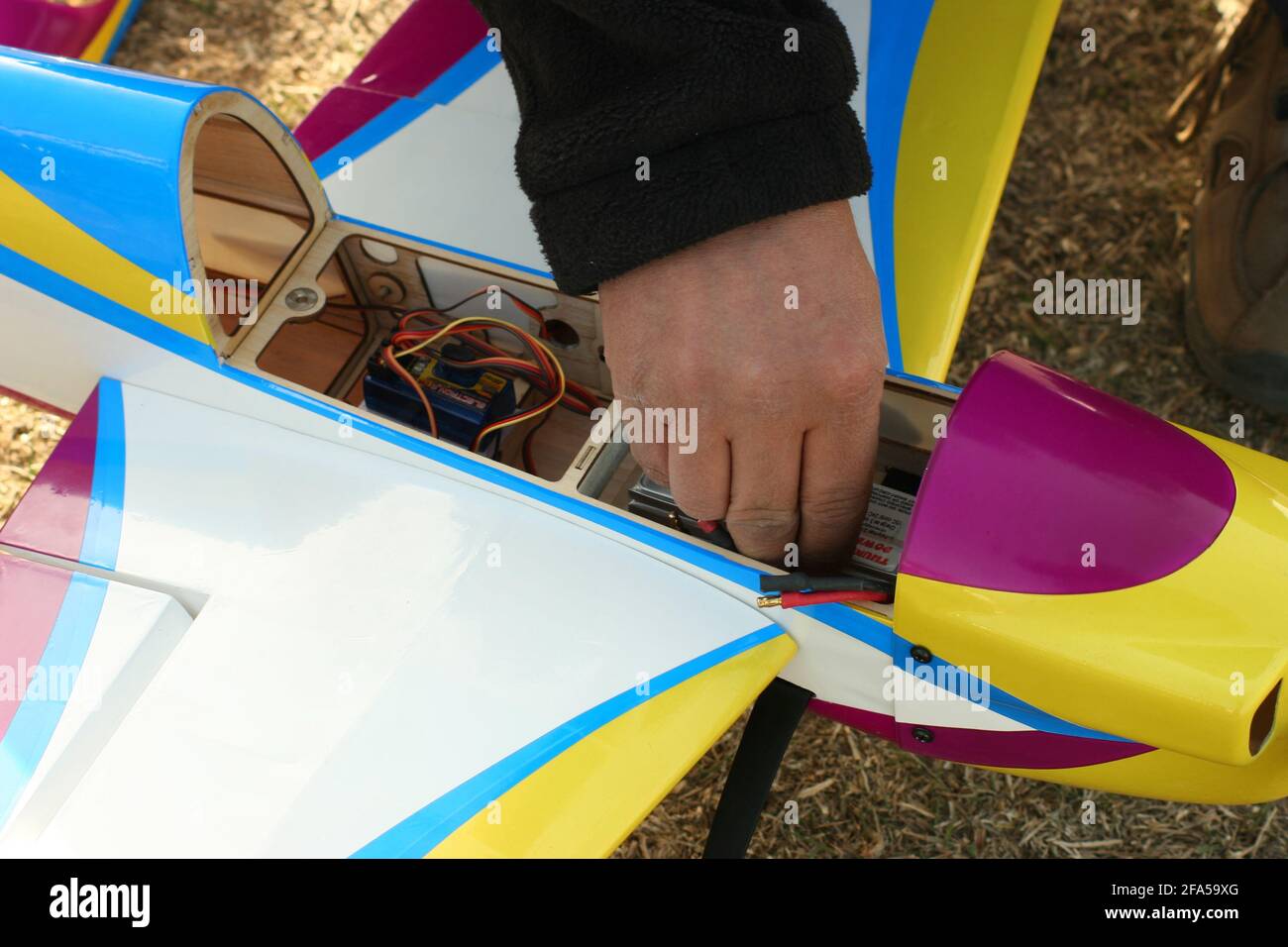 Hand insert the batteries in a model airplane Stock Photo - Alamy