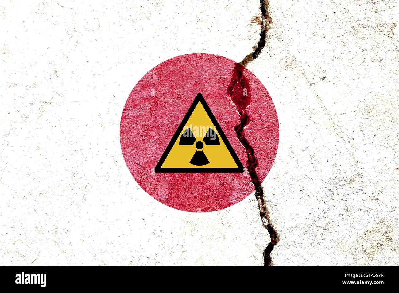 Yellow nuclear warning symbol on the Japan flag on cracked wall ...