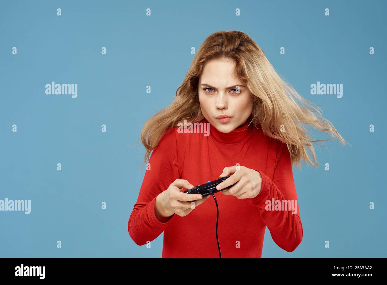 Pretty woman in red sweater joystick controller set-top box blue ...