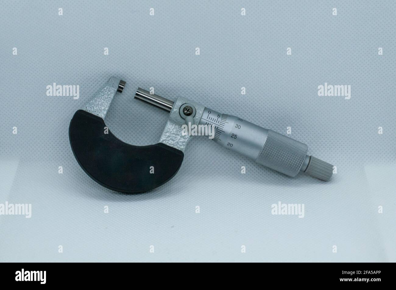 Micrometer tool on a plain white background Stock Photo - Alamy