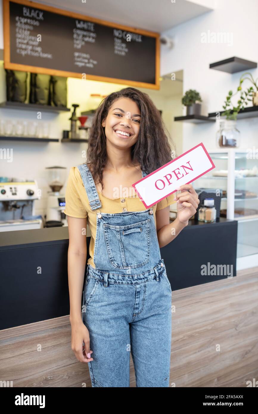 Shining woman holding sign in her hand Stock Photo - Alamy
