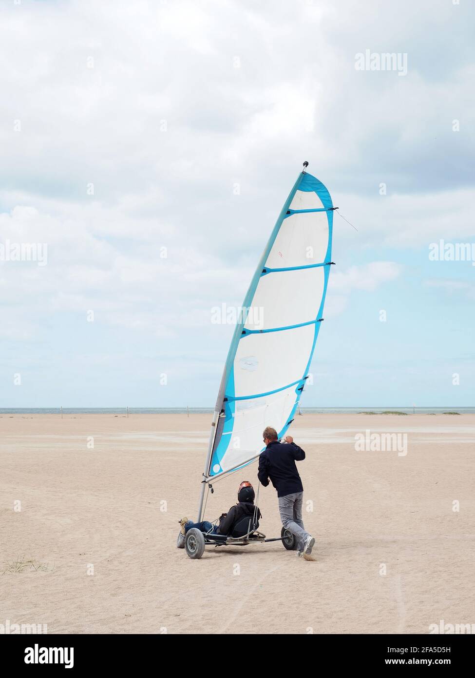 Sand yacht land sailing on beach Plage de Ouistreham in France. A man ...