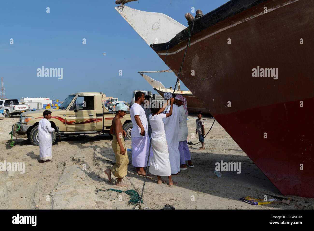 Fishing activities on the beach of Shannah, Oman. Men discussing under ...