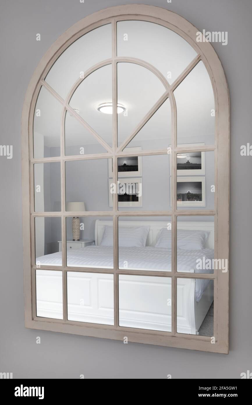 A large double bed reflecting in a mirror Stock Photo - Alamy
