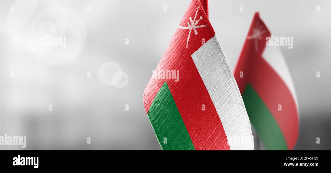 Small national flags of the Oman on a light blurry background Stock ...