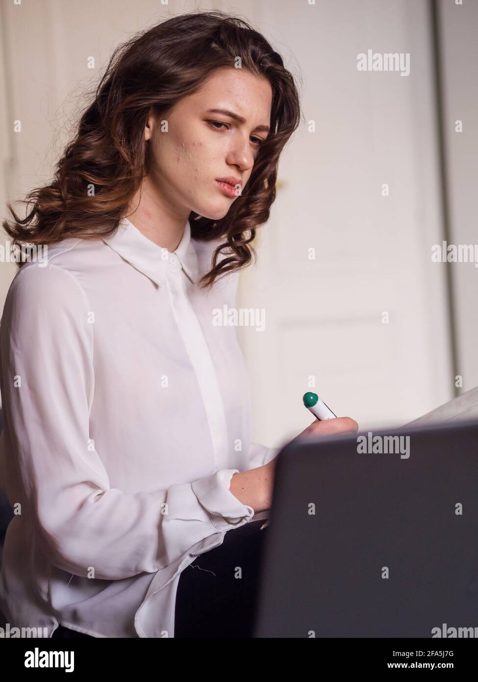 one young worried young woman, writing on whiteboard at her home Stock ...