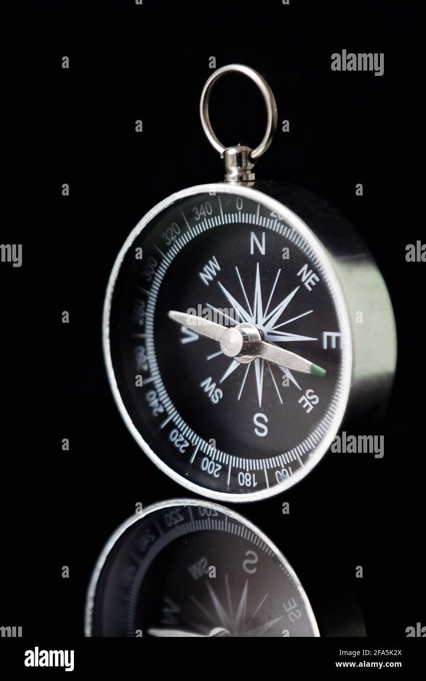 Compass on dark black background using as direction. Vertical image ...