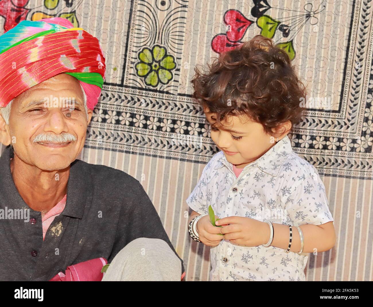 close-up portrait of An Indian-origin grandfather smiling in the garden ...
