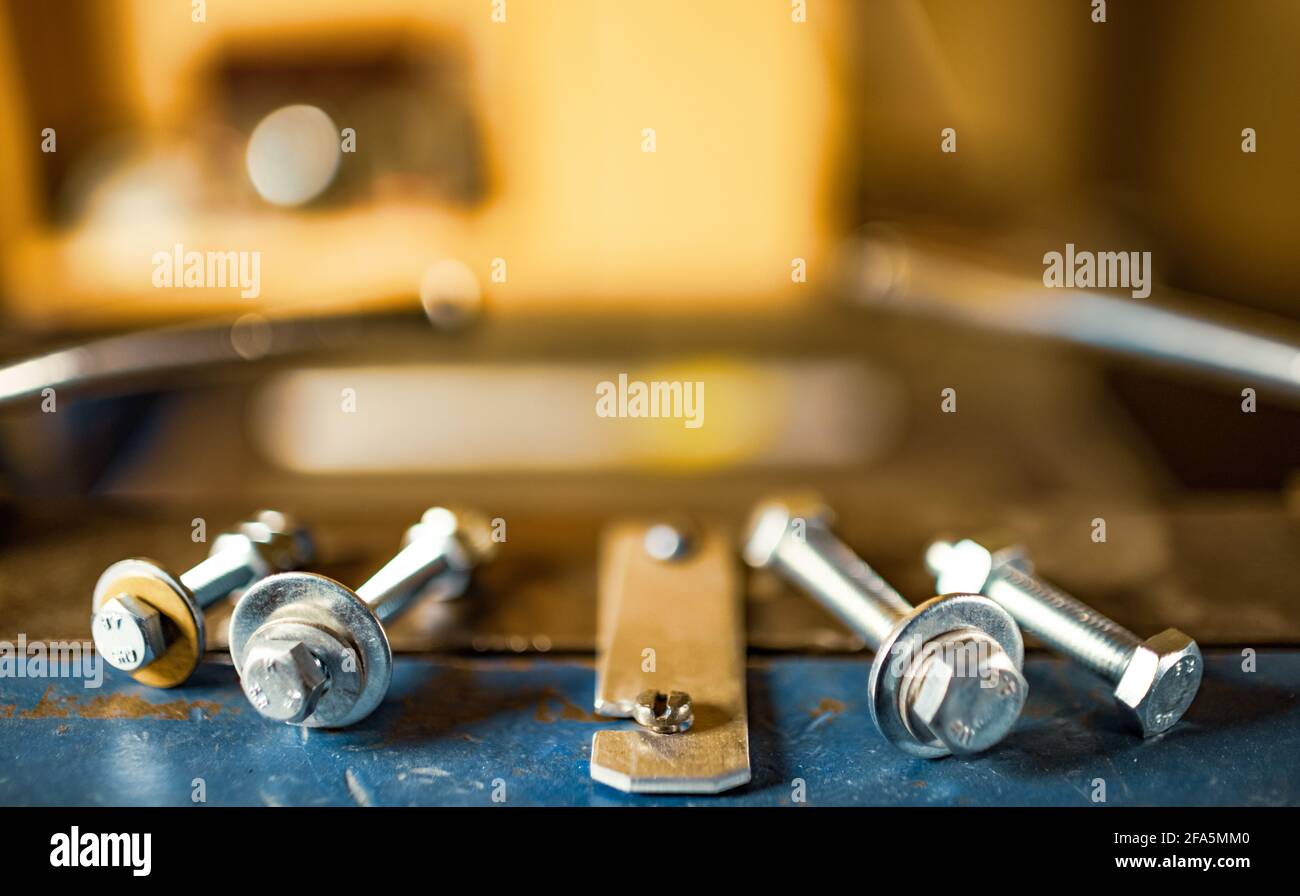 Metal chrome bolts and nuts on manual flexible massive machine. Old ...