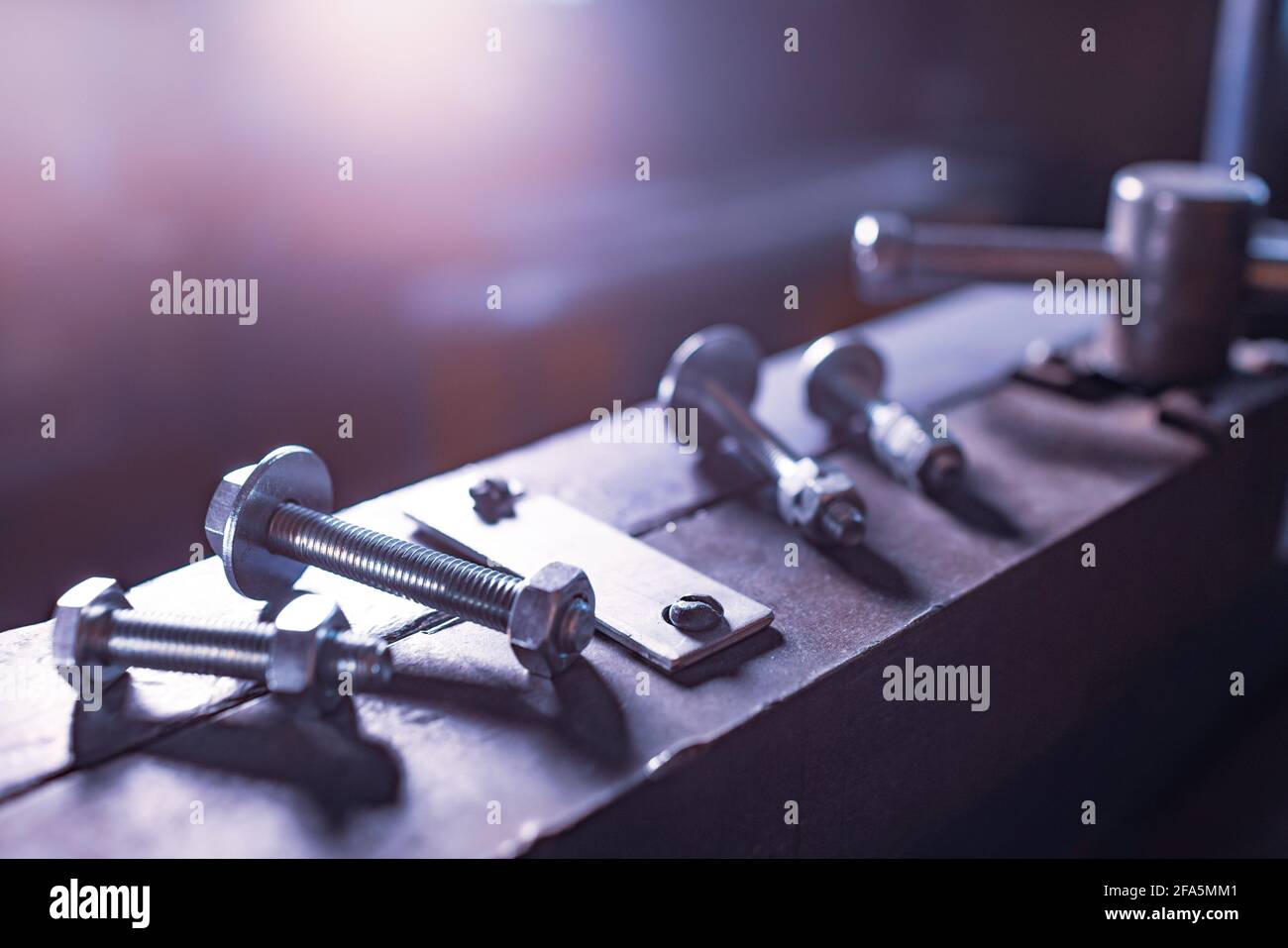 Metal chrome bolts and nuts on manual flexible massive machine. Old ...