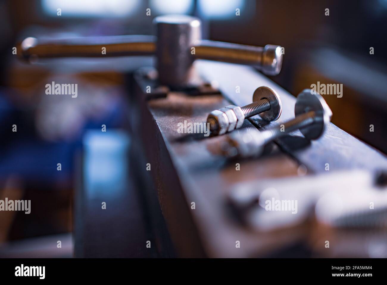 Metal chrome bolts and nuts on manual flexible massive machine. Old ...