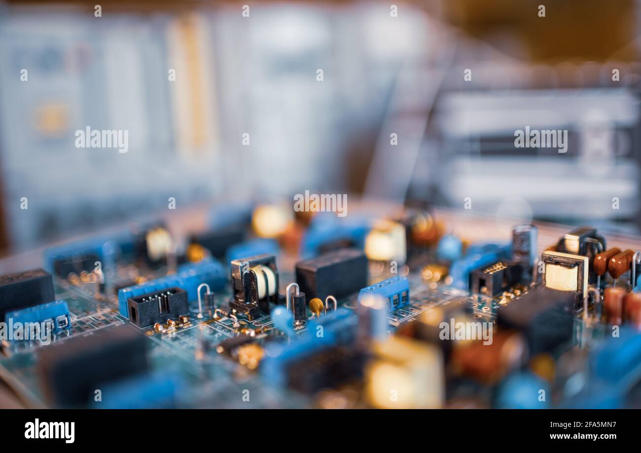 Microcircuits and components lie on metal plates during the production ...