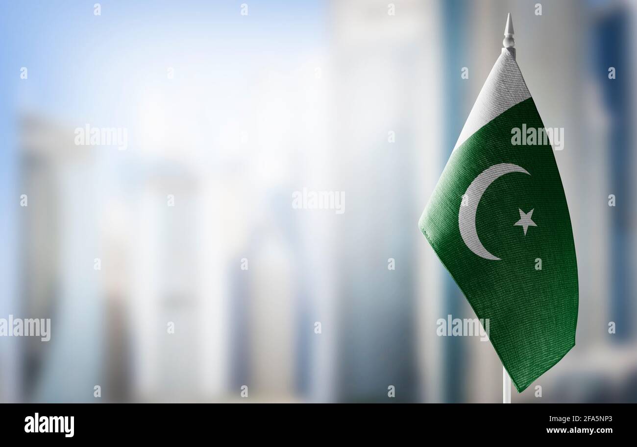 A small flag of Pakistan on the background of a blurred background ...