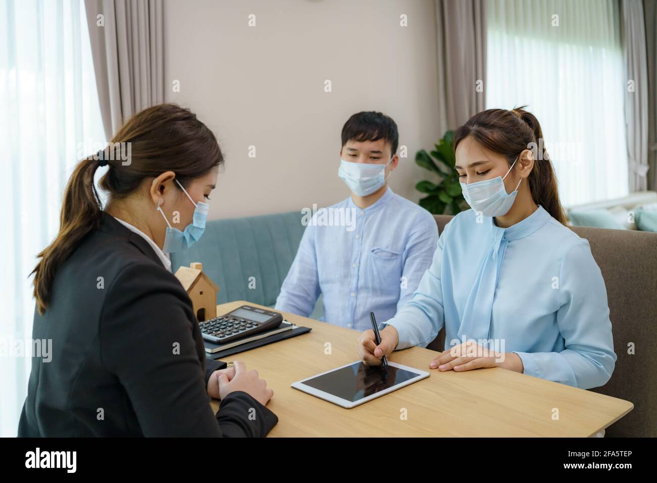 Asian Womans Real Estate Agents Are Having Clients Sign Contracts To Sell Their Homes In