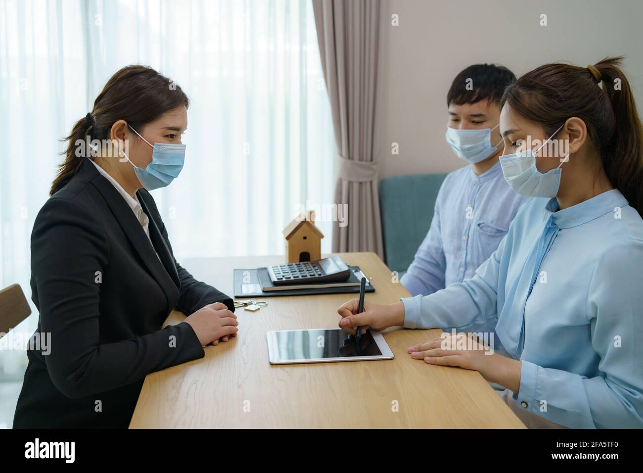 Asian Womans Real Estate Agents Are Having Clients Sign Contracts To Sell Their Homes In