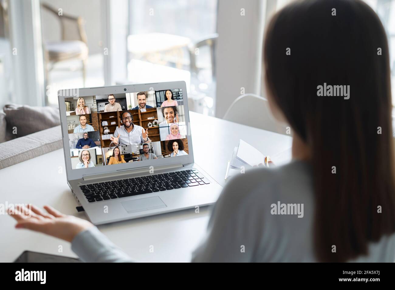 Female freelancer talking online with group of diverse colleagues or ...