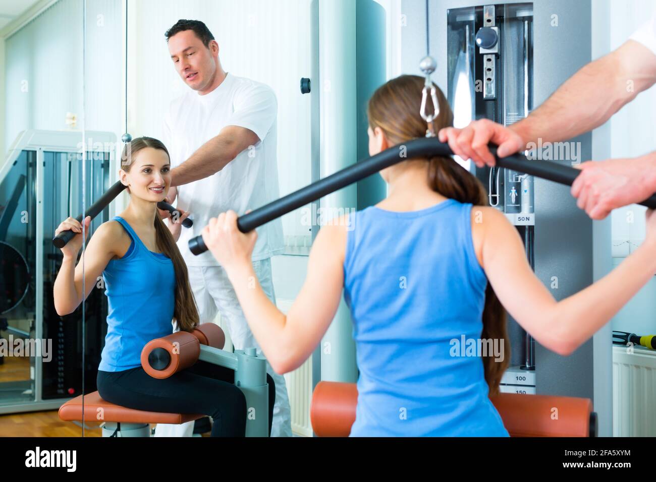 Patient at the physiotherapy making physical exercises with her ...