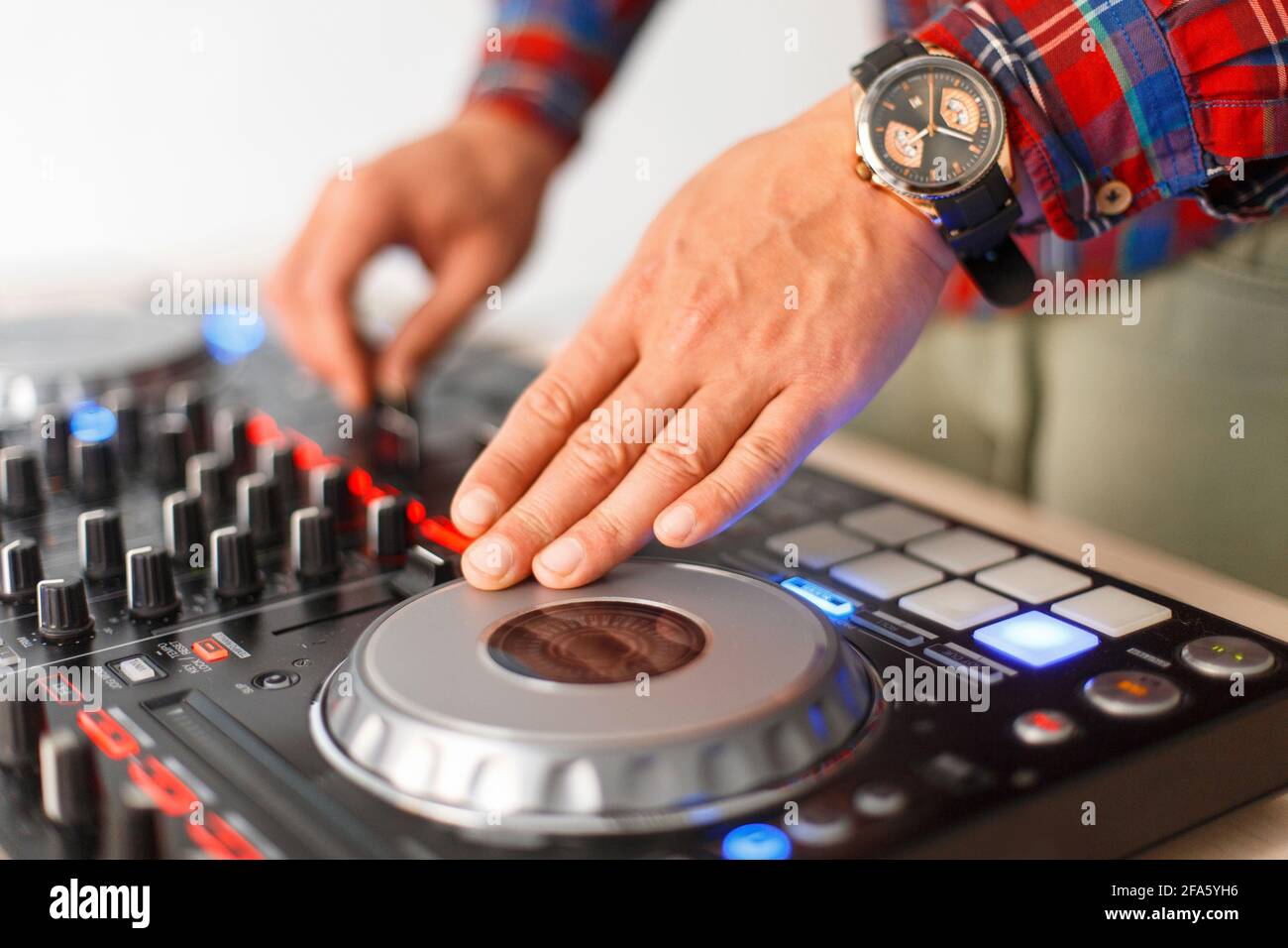 Man DJ Plays On The Mixing Console Close-up Stock Photo - Alamy