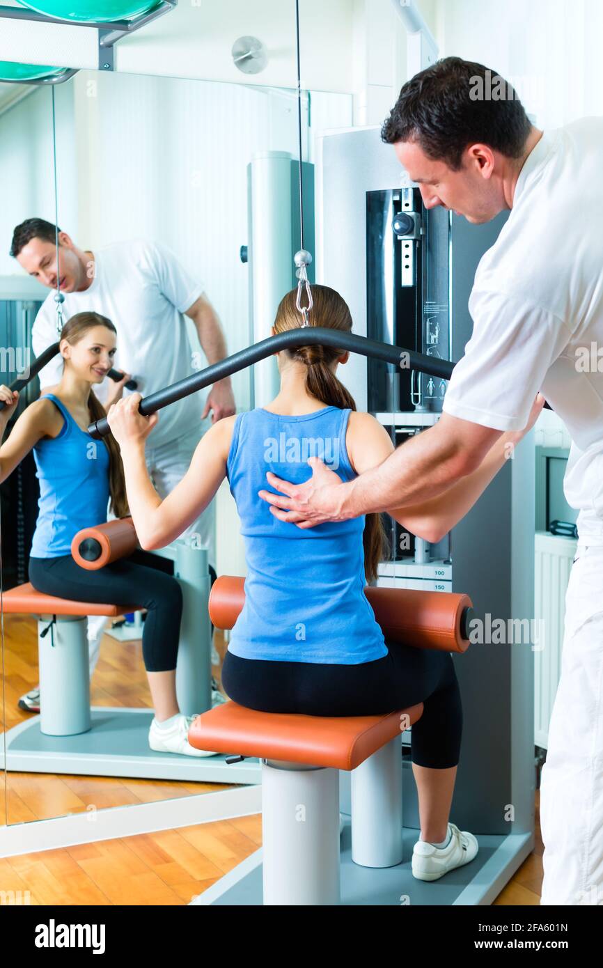 Patient at the physiotherapy making physical exercises with her ...